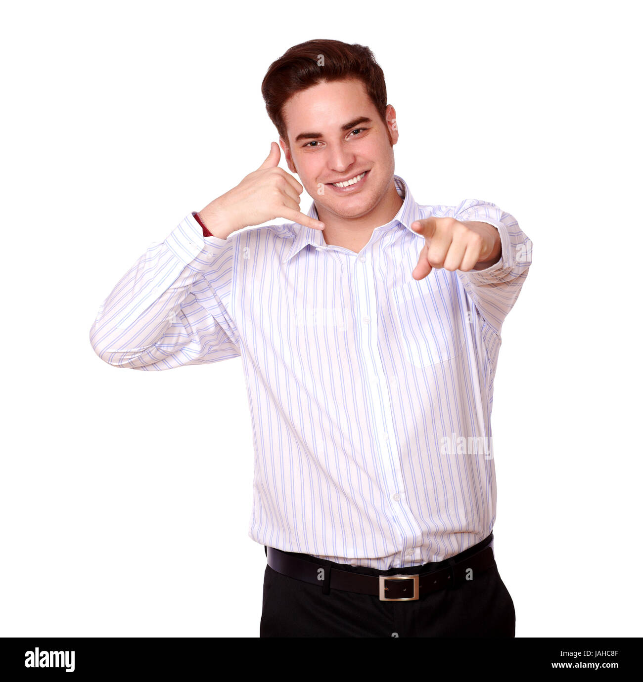 Portrait of an attractive young guy with calling gesture smiling and ...