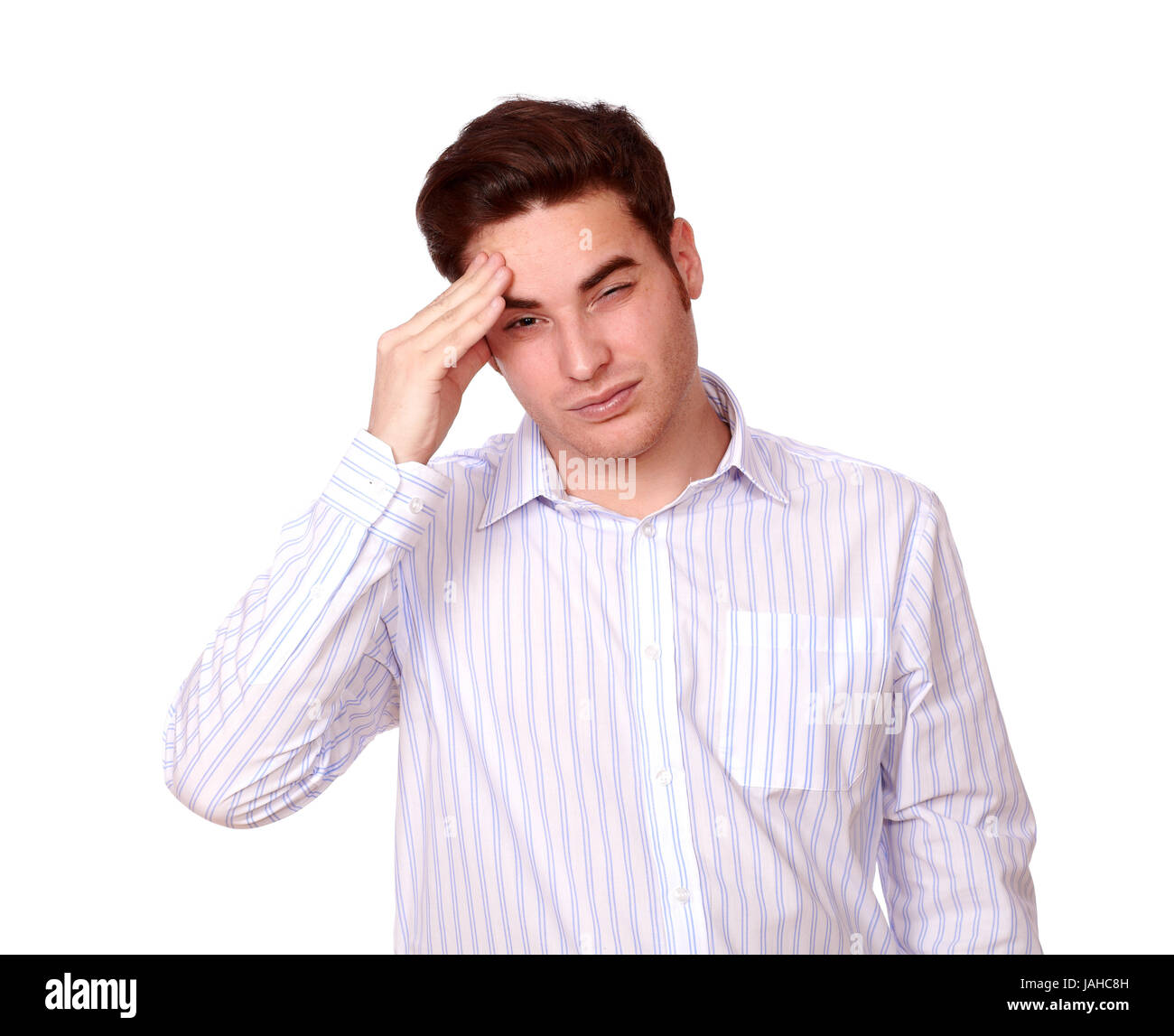 Portrait of a fatigue young man on white shirt with headache standing ...