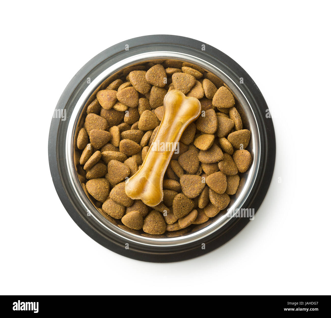 Dog chew bone and dry kibble dog food in bowl isolated on white ...