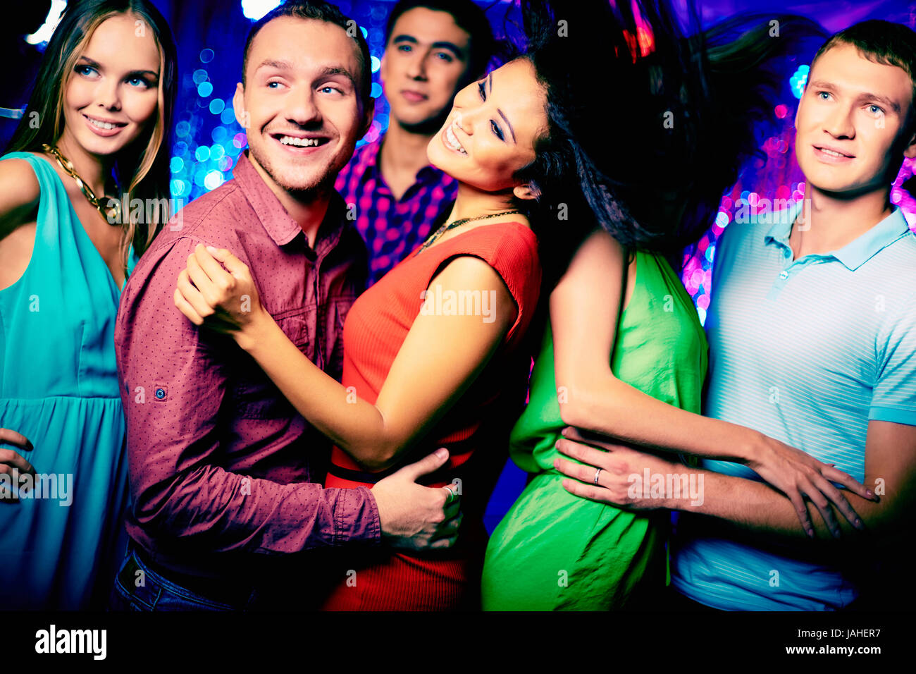 Happy young friends dancing at disco Stock Photo - Alamy