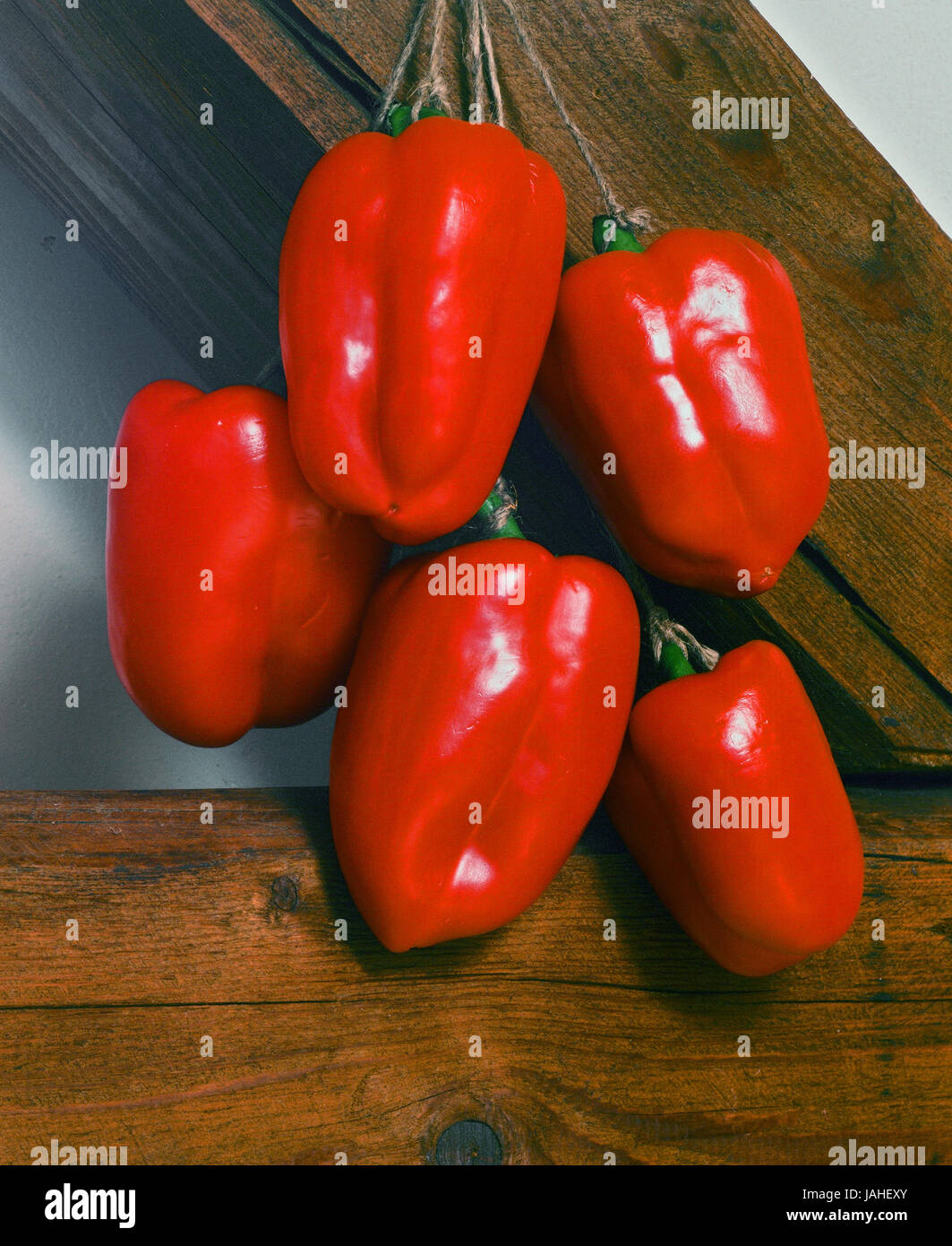 bunch of red bell pepper hanging on a joist Stock Photo - Alamy