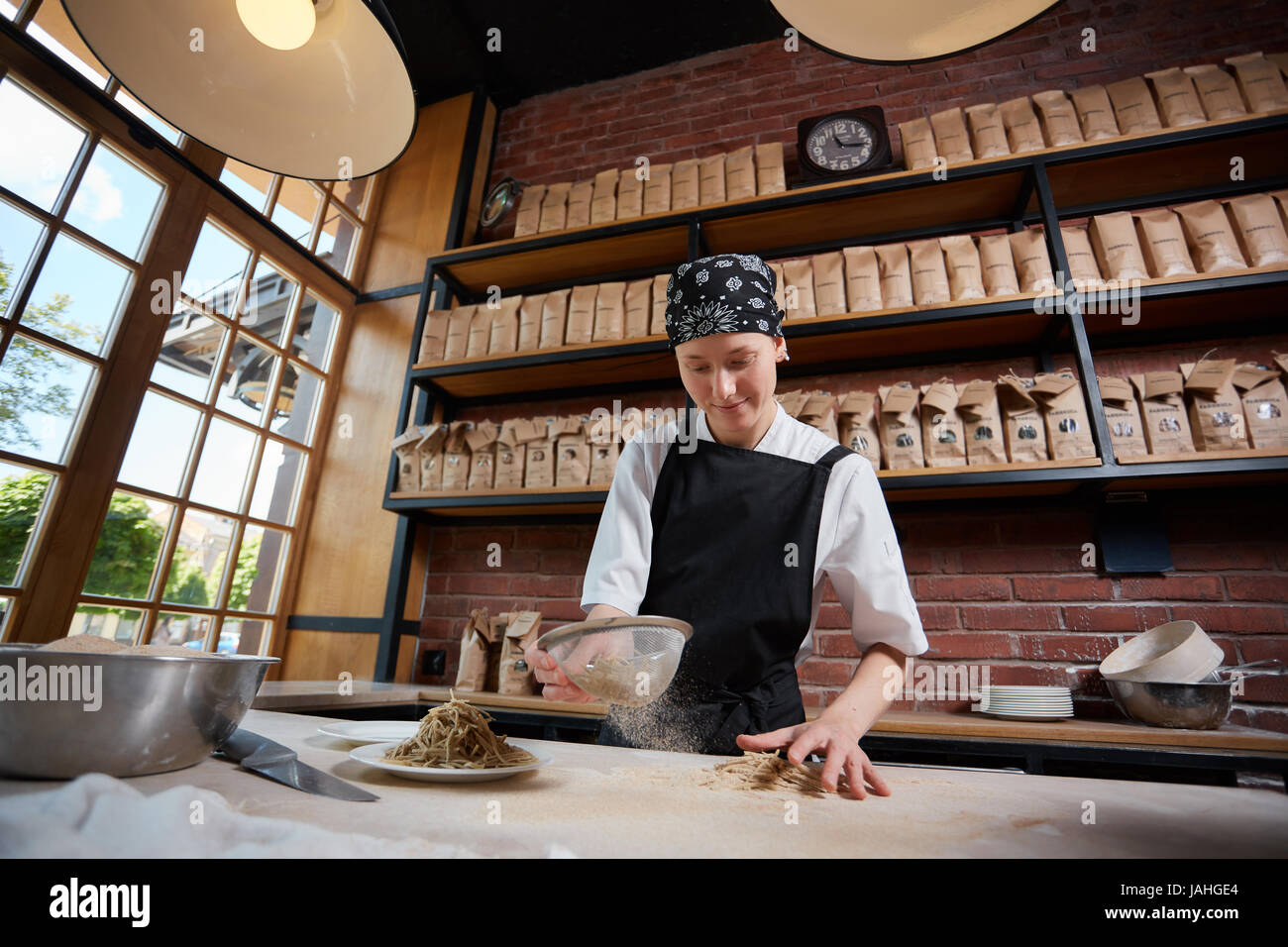 Woman working with floor cooking pasta Stock Photo - Alamy