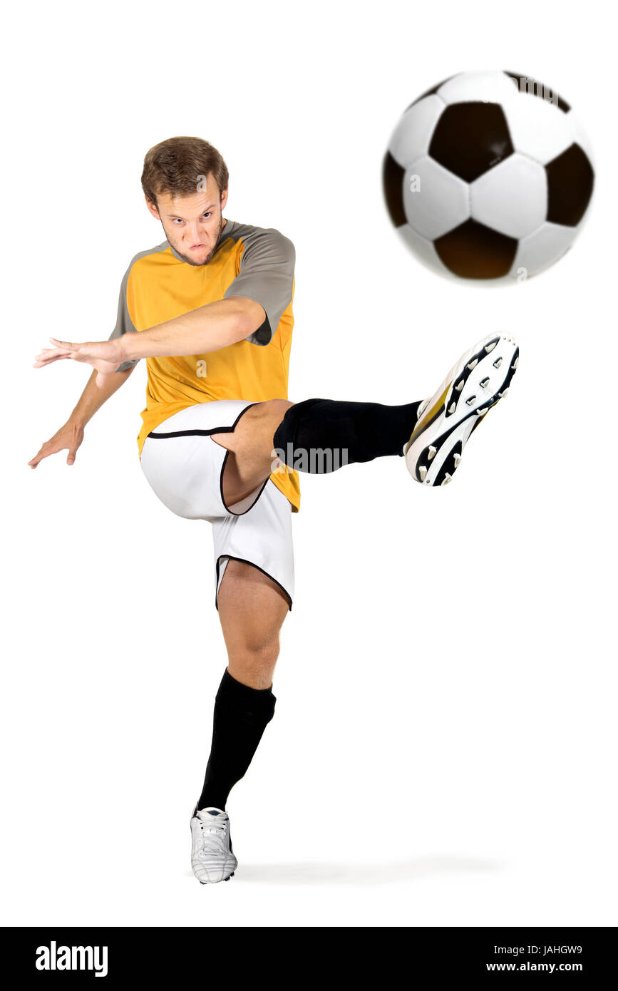Football player kicking a ball isolated in white Stock Photo - Alamy