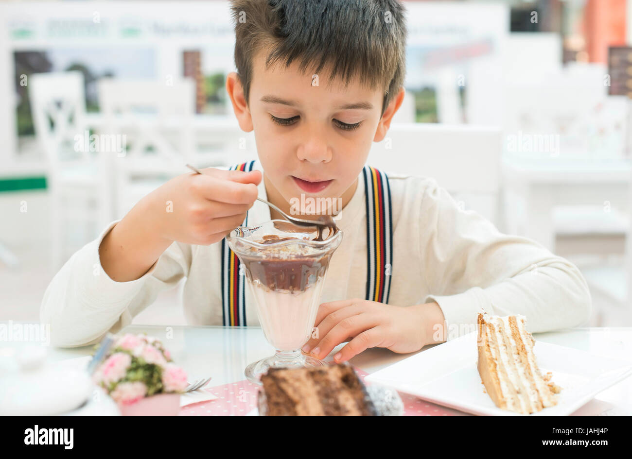 Child eat milk choco shake on a table Stock Photo - Alamy
