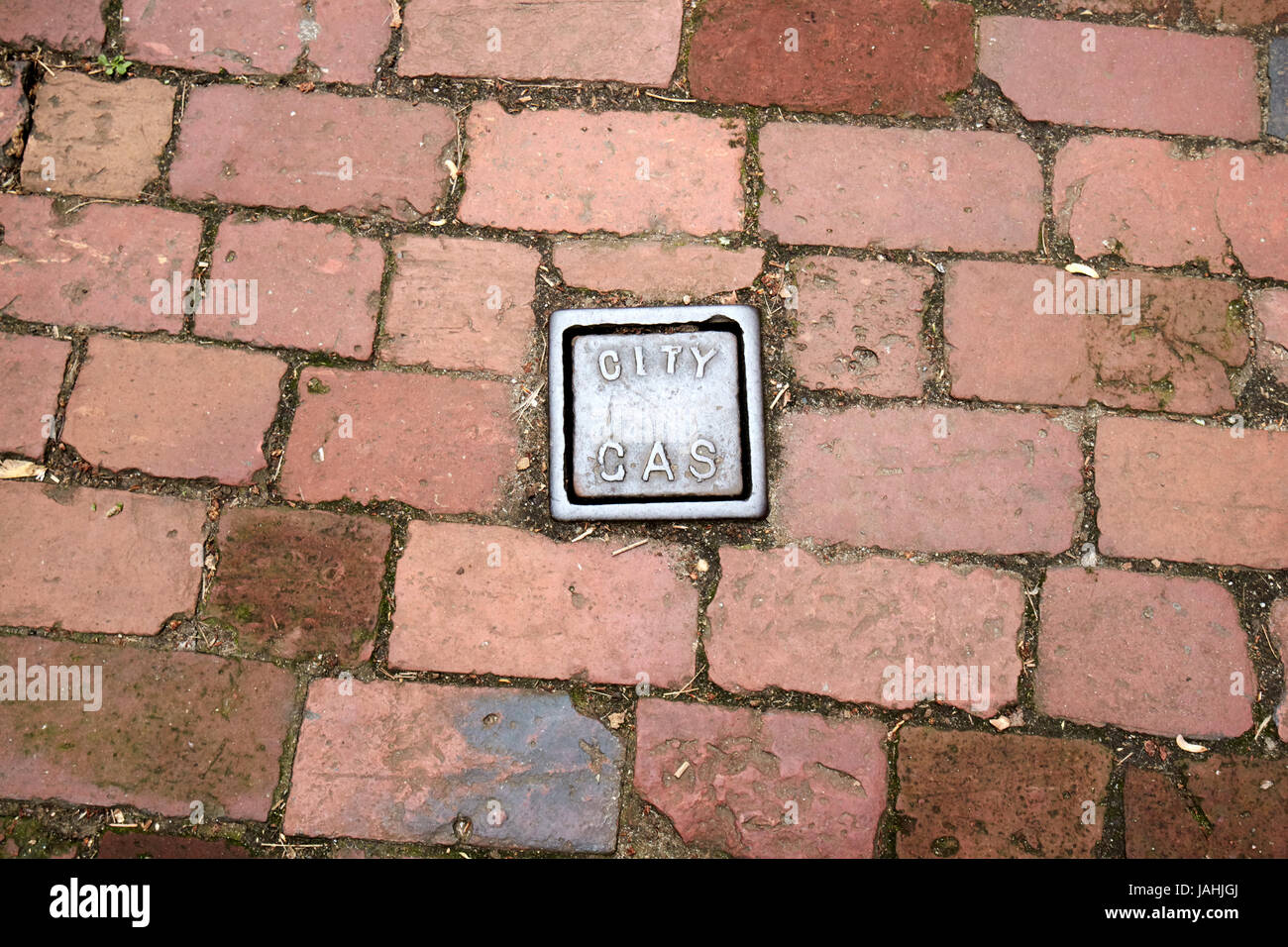 city gas access point in the red brick sidewalk in the old city of ...