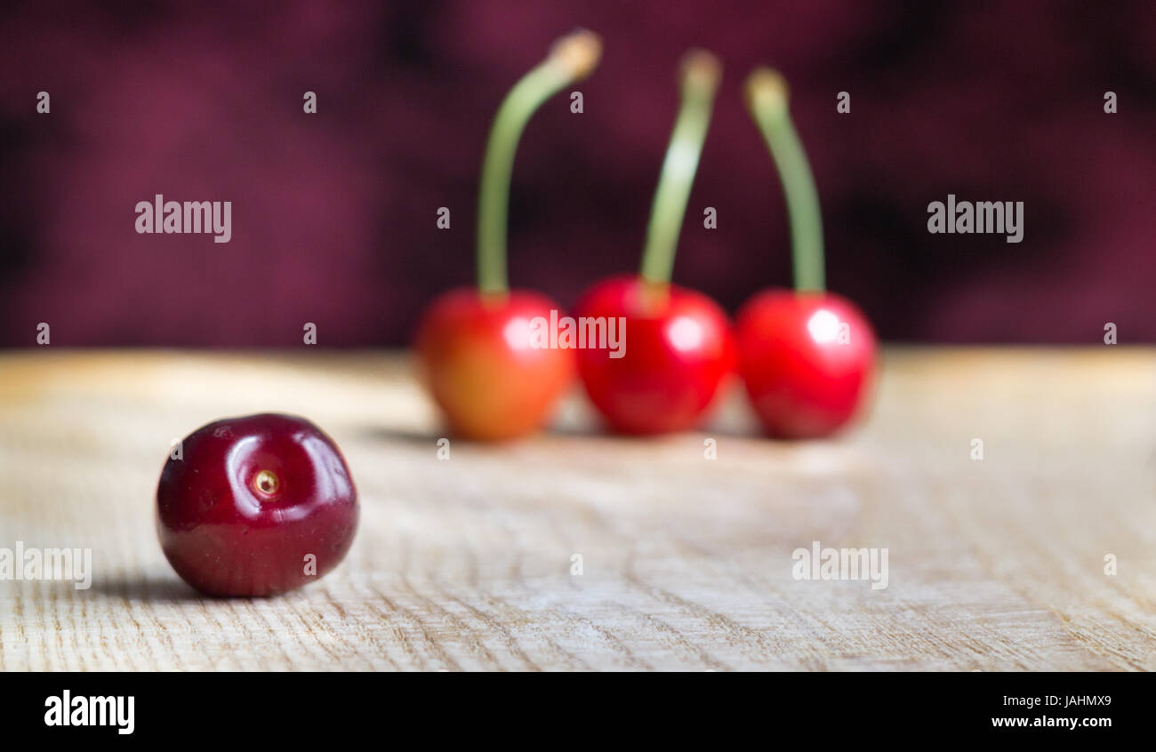 Conceptual image with cherries on a table, unique, individuality ...