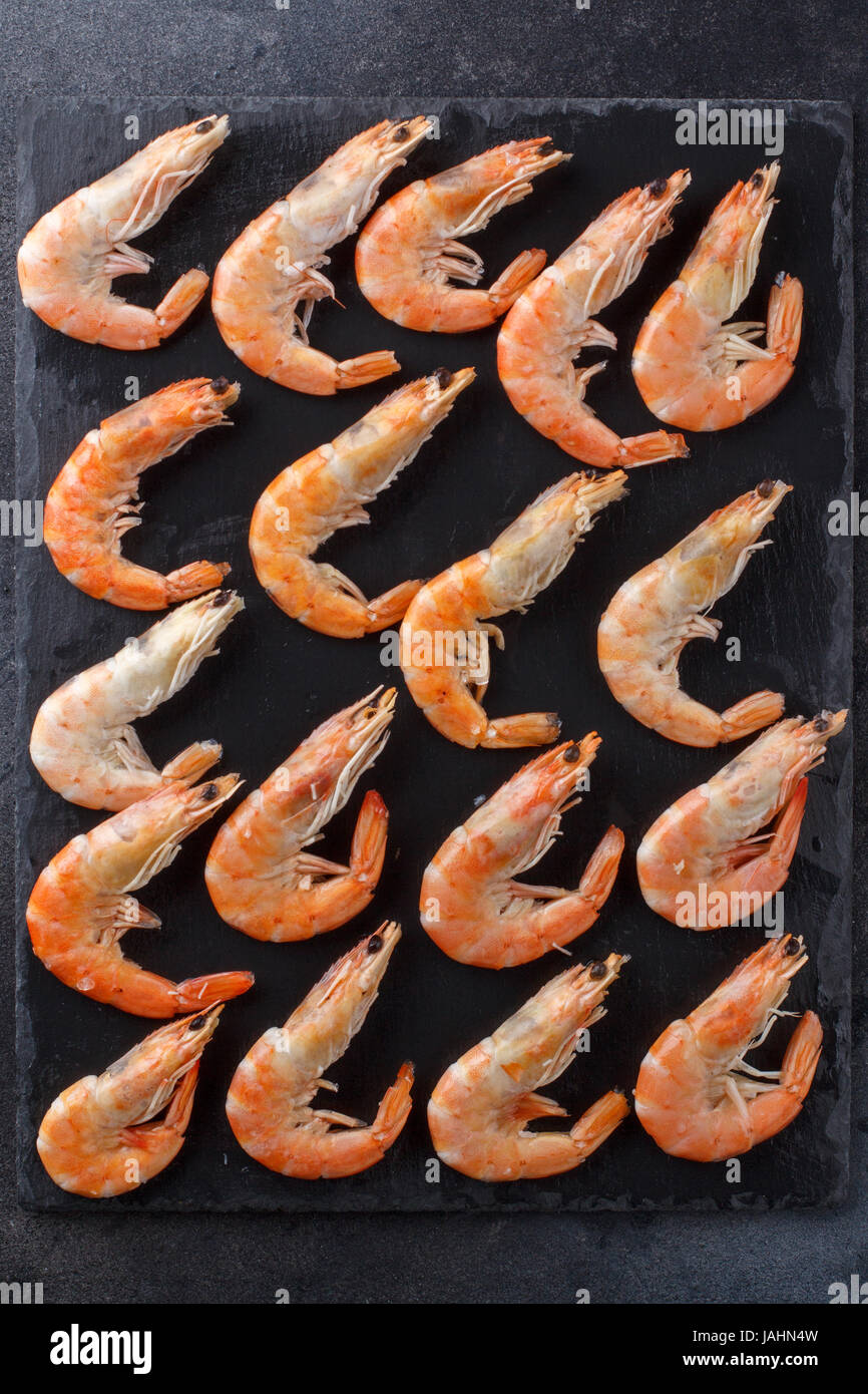 A lot of shrimp on a black background. Good selection of raw shrimps ...
