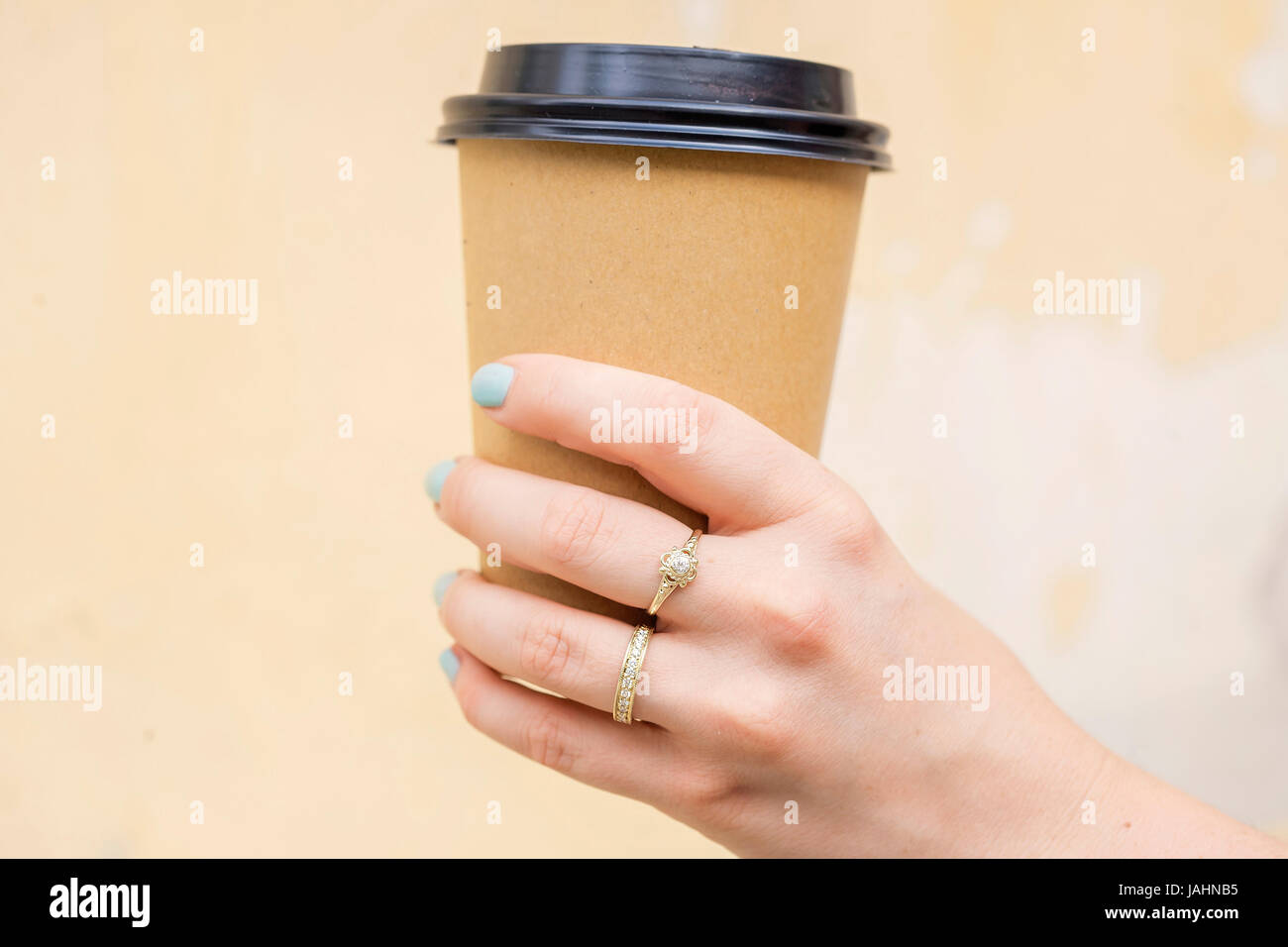 Female hand with cup and beautiful jewelry Stock Photo - Alamy