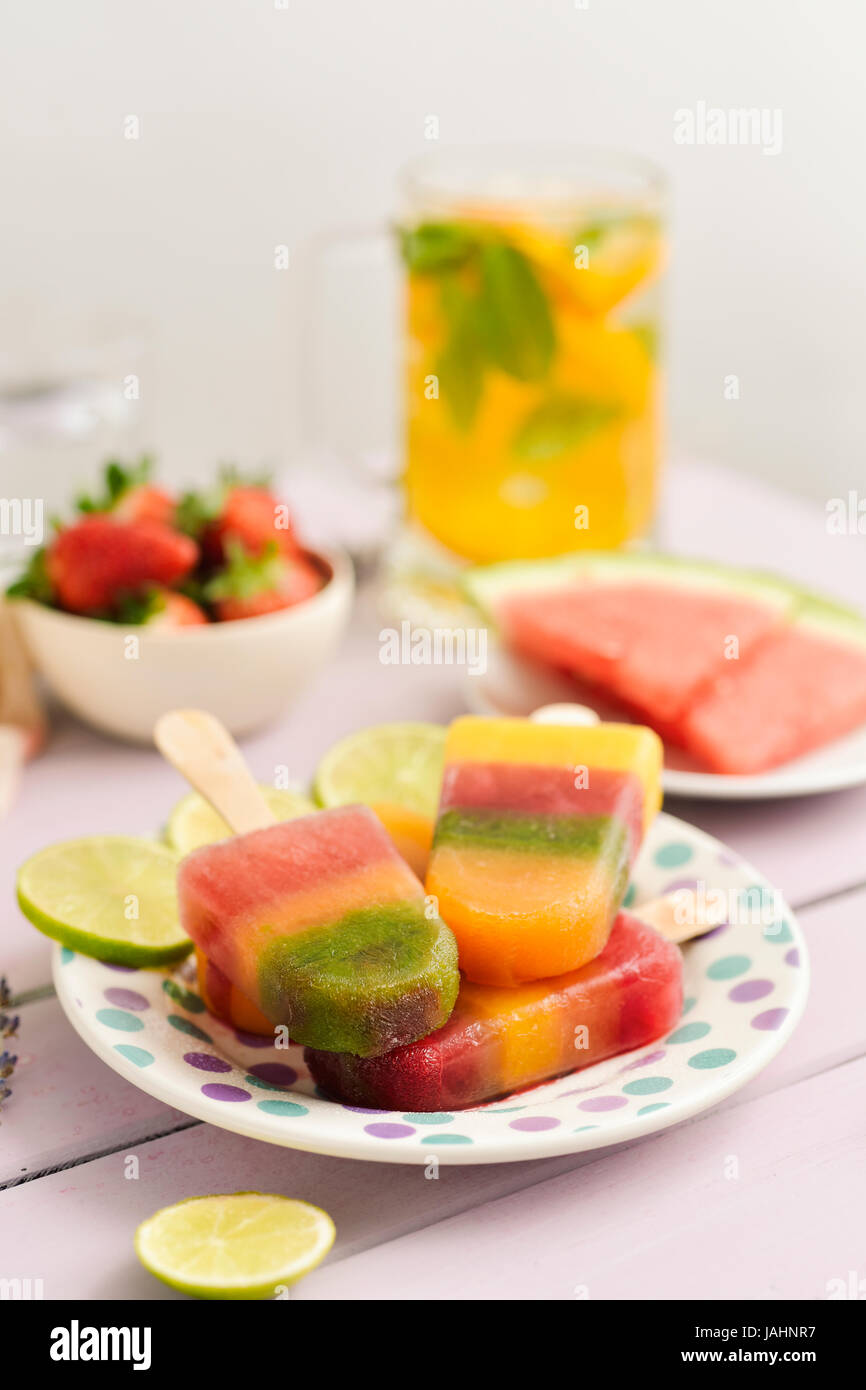 some different homemade natural ice pops in a ceramic plate next to ...