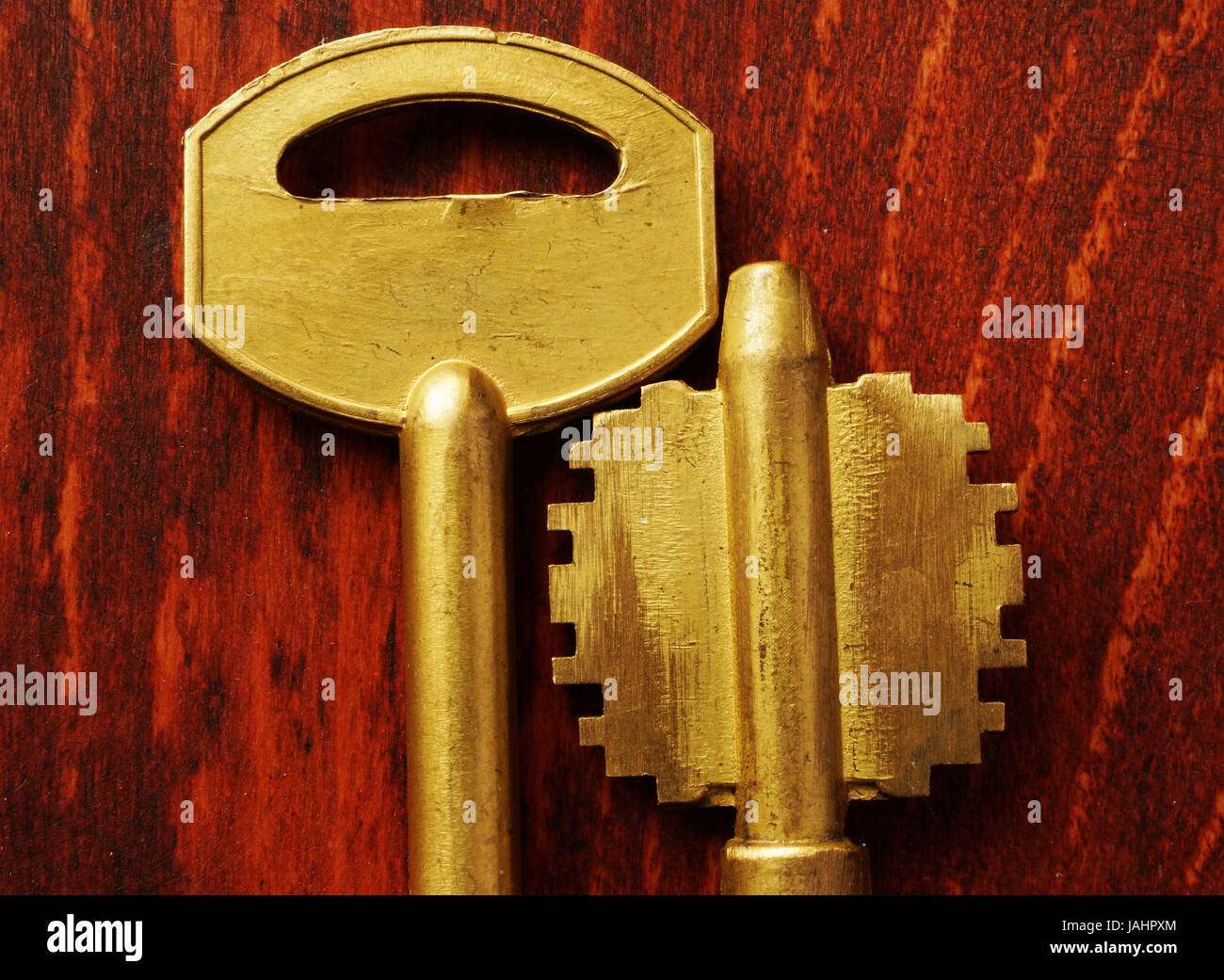 Two keys on a dark wooden background Stock Photo - Alamy