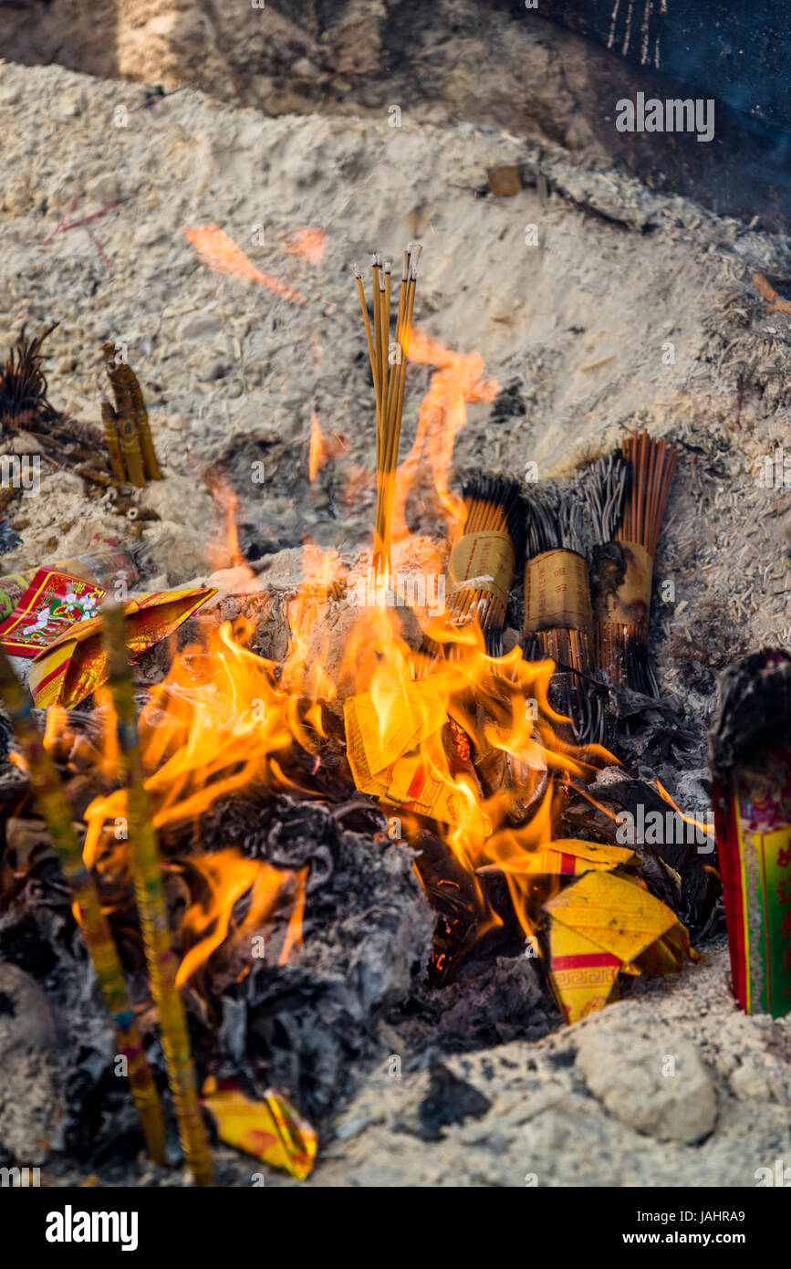 Taoist religious ritual of burning insence and pieces of papers on ...