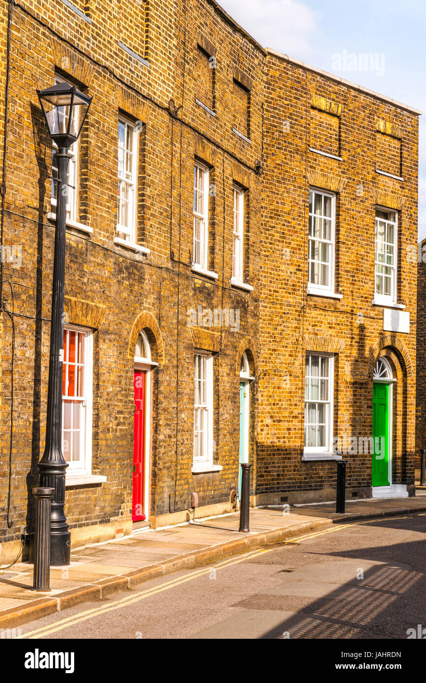 Typical old English buildings, low brick buildings across a narrow ...