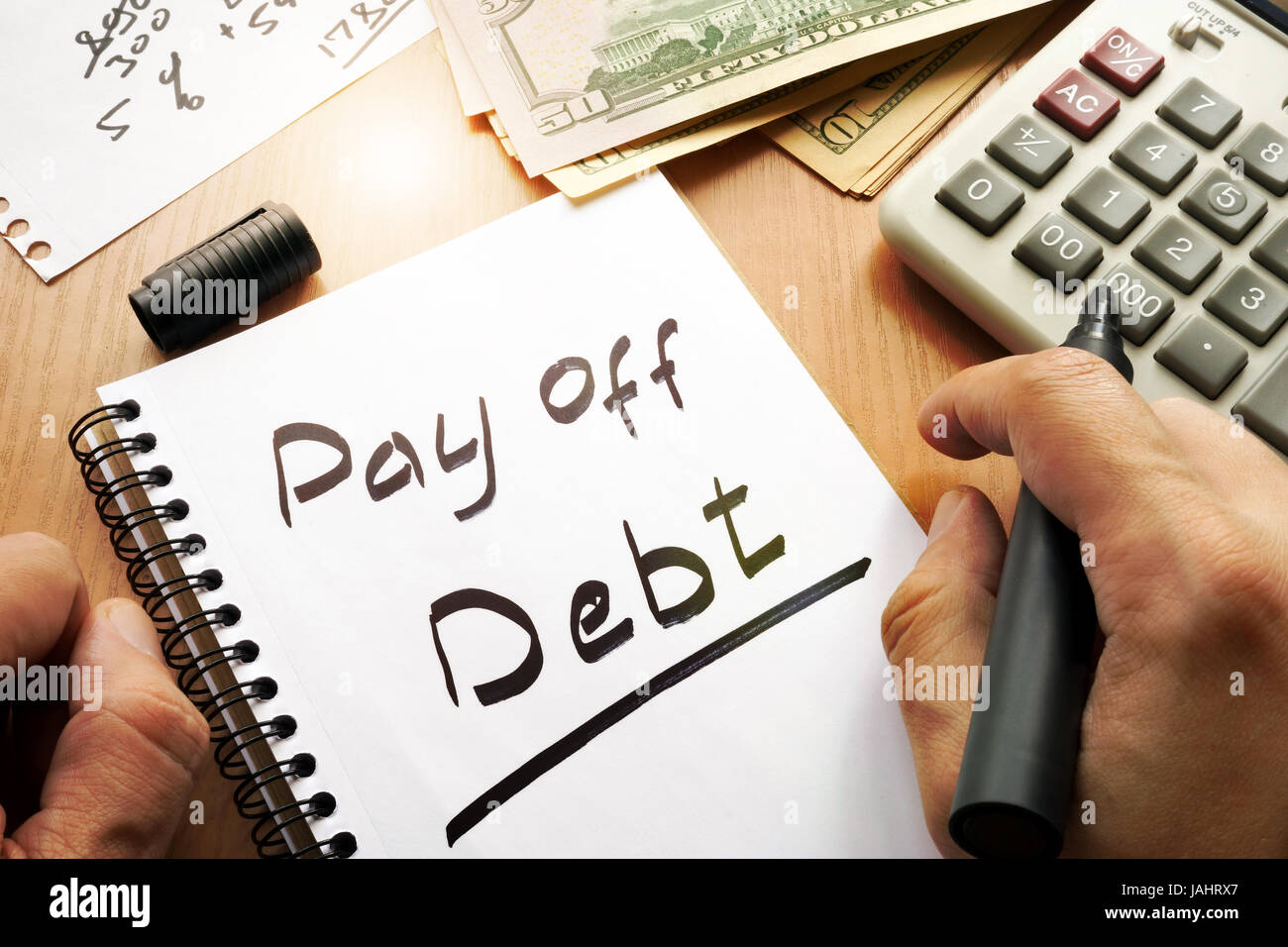 Note with words pay off debt concept Stock Photo - Alamy
