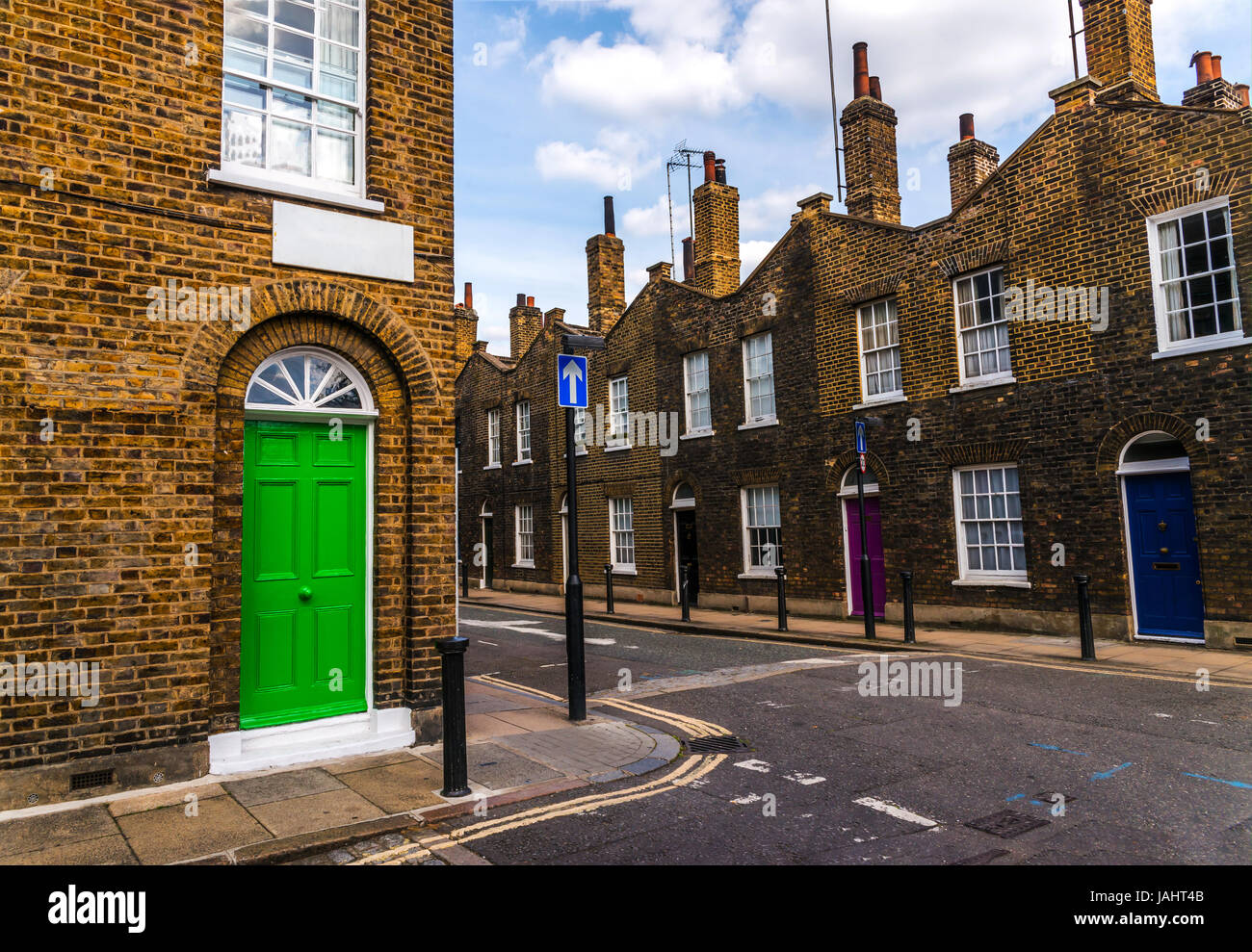 Typical old English buildings, low brick buildings across a narrow ...
