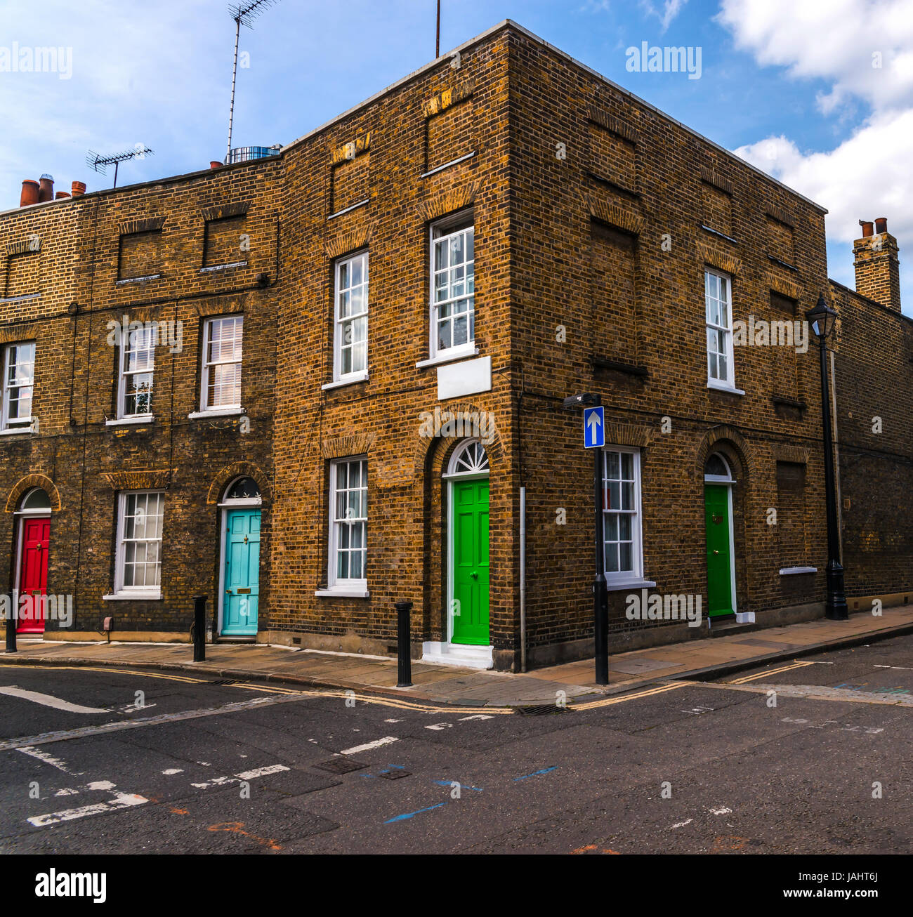 Typical old English buildings, low brick buildings across a narrow ...