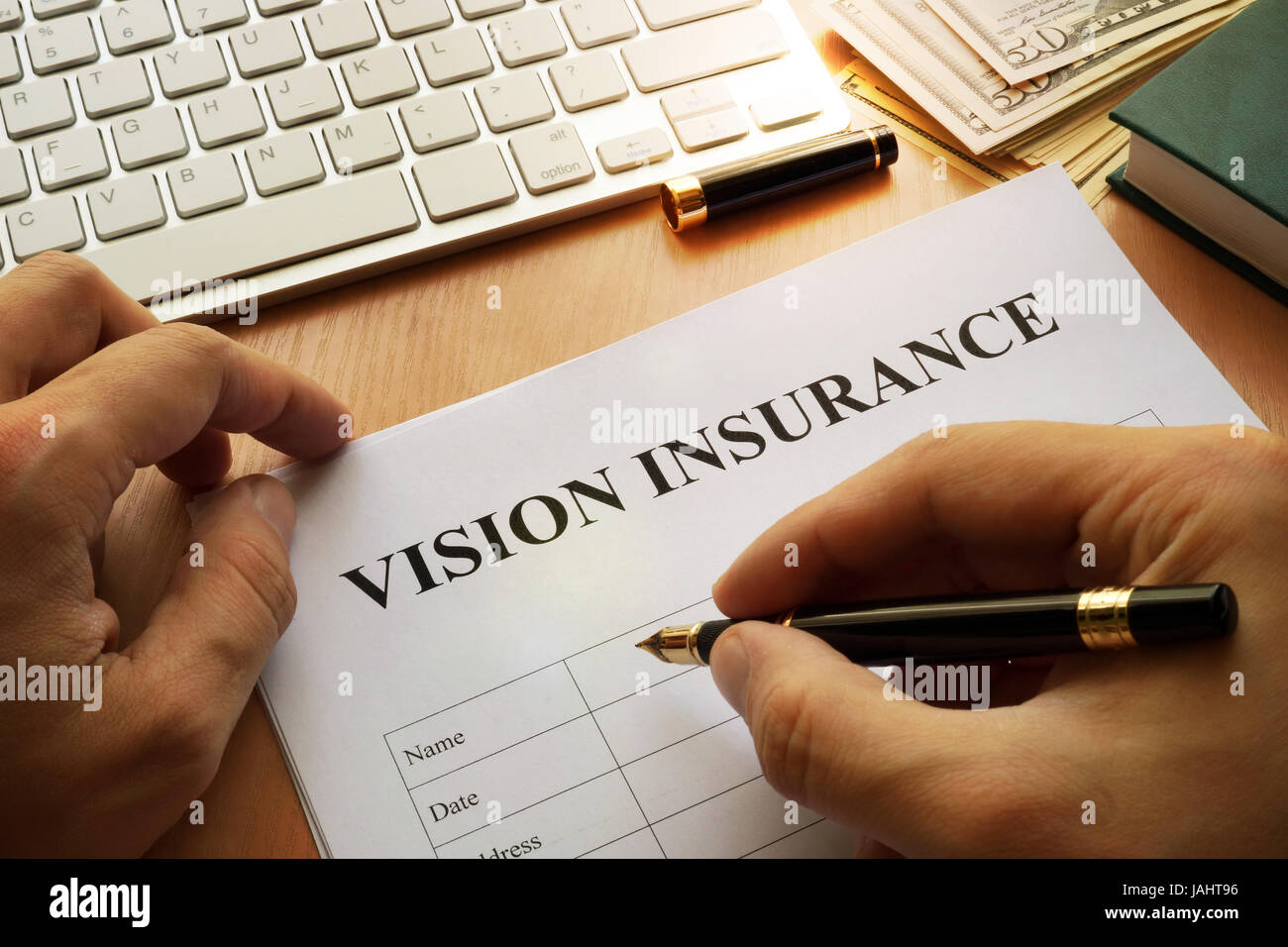 Vision insurance policy on a office table Stock Photo - Alamy