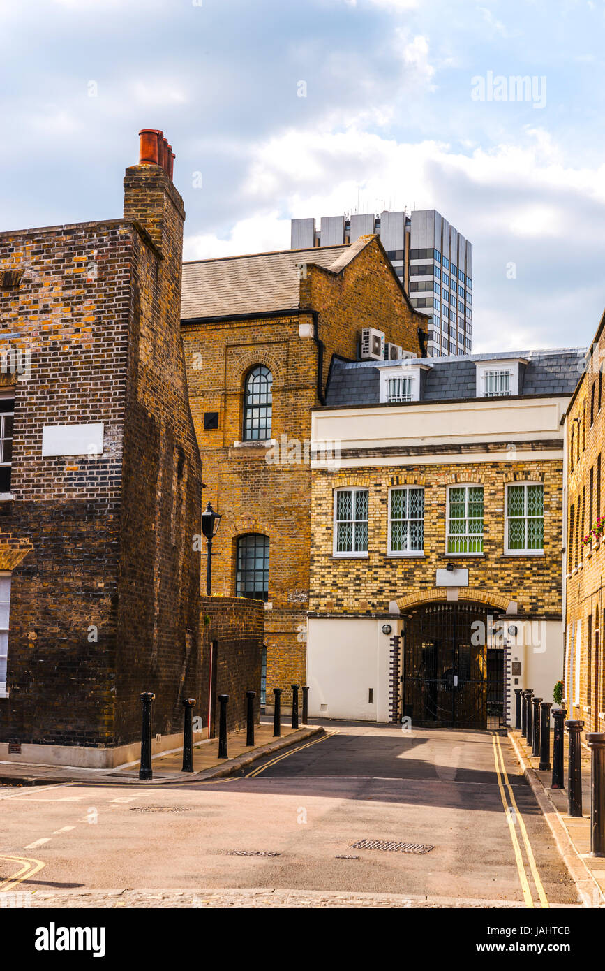 Typical old English buildings, low brick buildings across a narrow ...