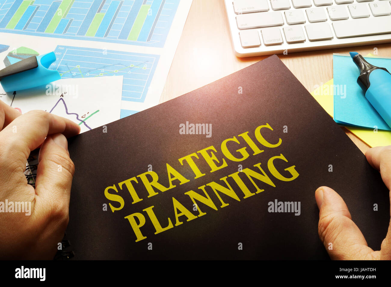 Hands holding documents with title strategic planning Stock Photo - Alamy
