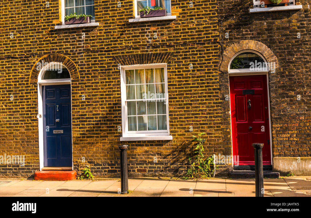 Typical old English buildings, low brick buildings across a narrow ...