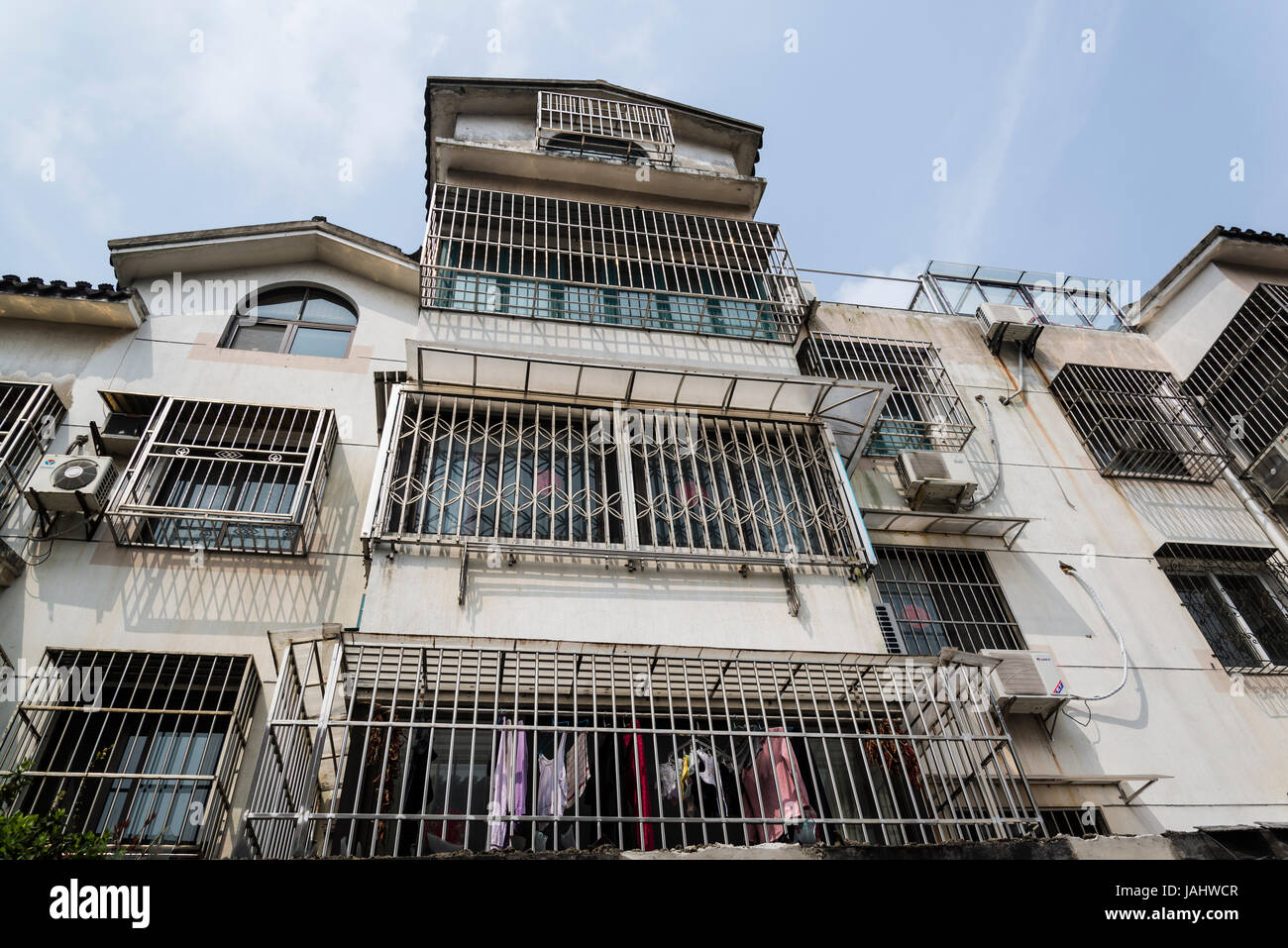 Bared windows and balconies on several storey residential building ...