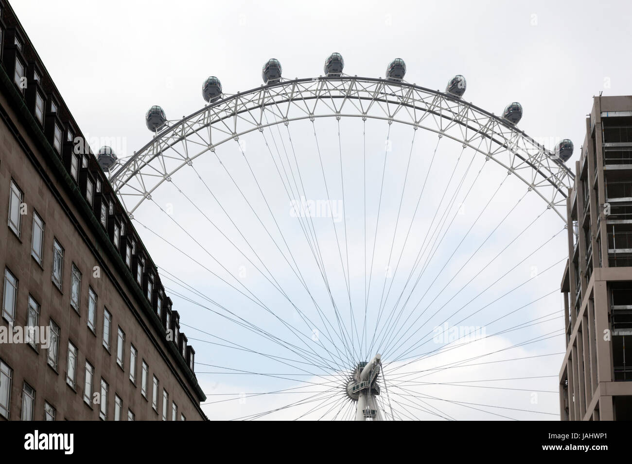 London eye behind building london hi-res stock photography and images ...