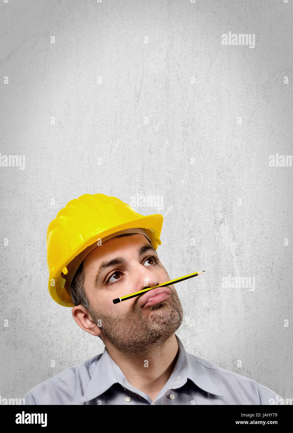 Engineer with a helmet on his head, reflecting staring into the void ...