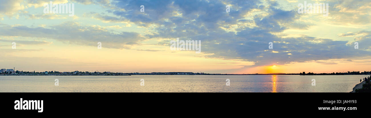 Orange sunset over a european lake, blue clouds sky, colored dramatic ...