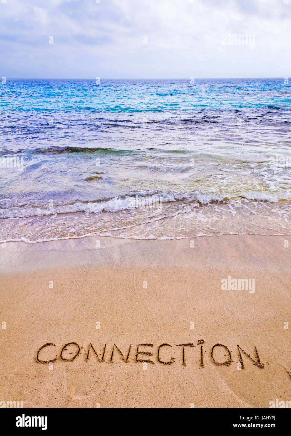 Connection word written on sand, with waves in background, connecting ...
