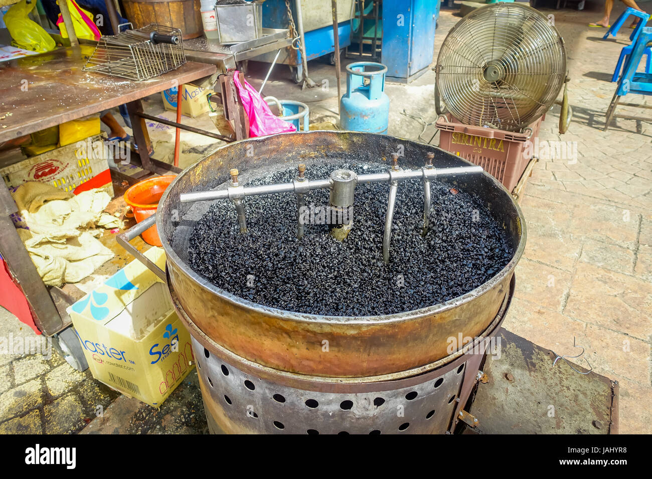 Pot with hot pebbles to roast chestnuts, street food in Chinatown ...
