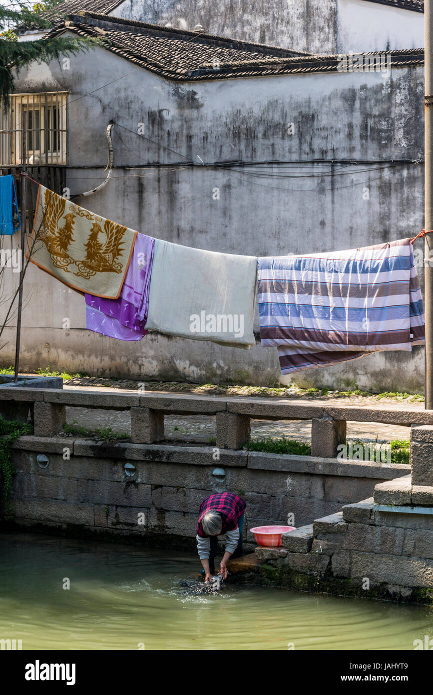 Woman washing clothes in the canal, Pingjiang Road, ancient district ...