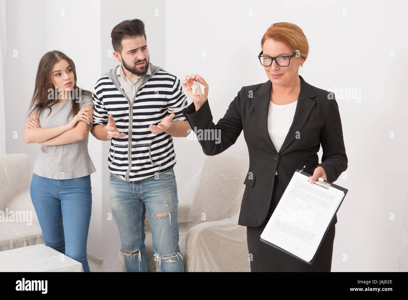 Unscrupulous renters arguing with estate agent, who keeps keys and ...