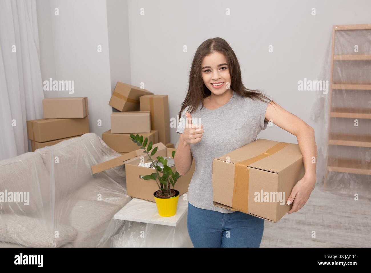 Beautiful girl moving in the new apartment Stock Photo - Alamy