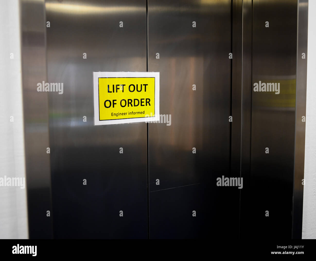 A lift with a sign on saying that the lift is Out of Order Stock Photo ...