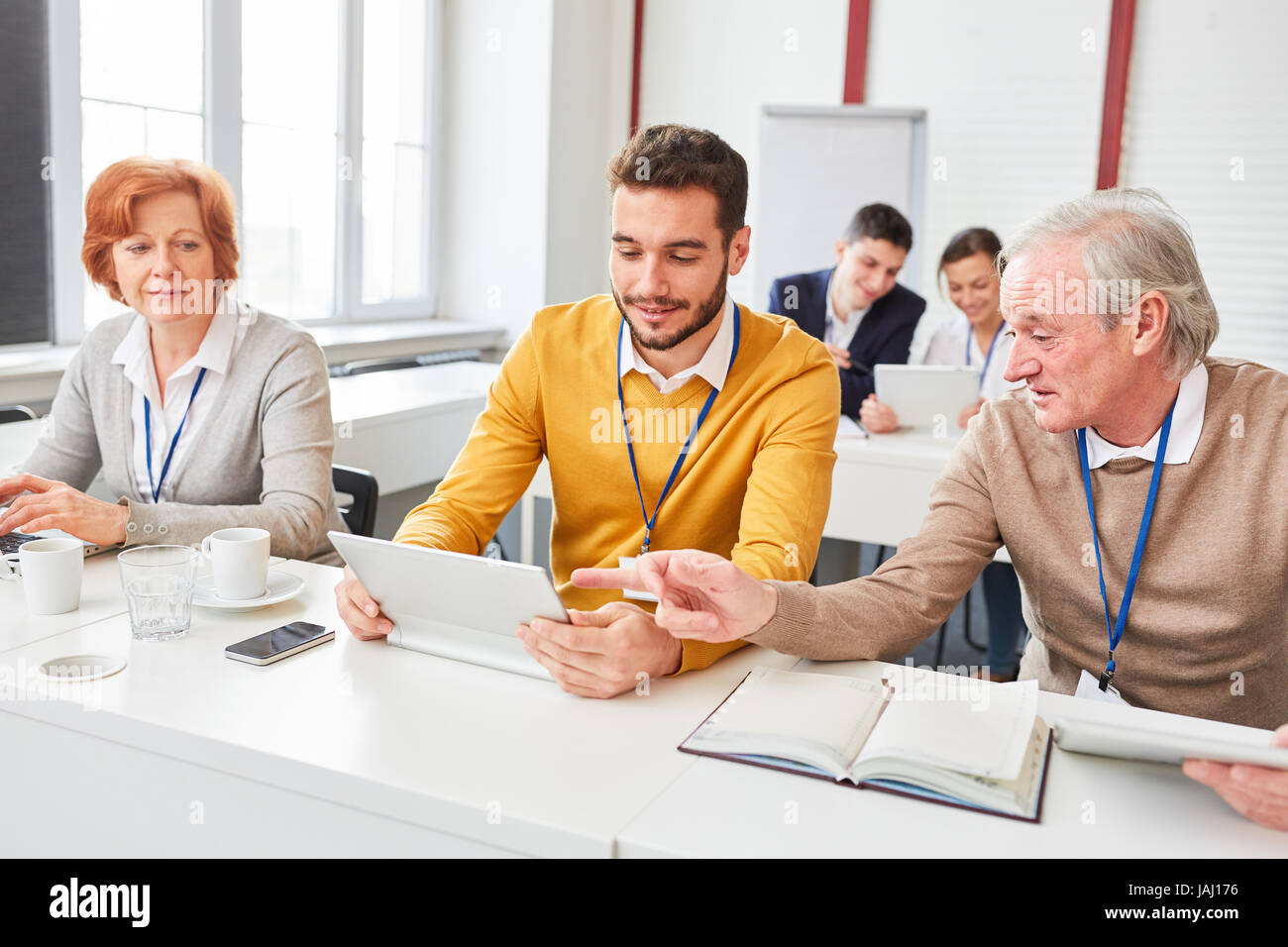 Senior in business training working in teamwork with colleagues Stock ...