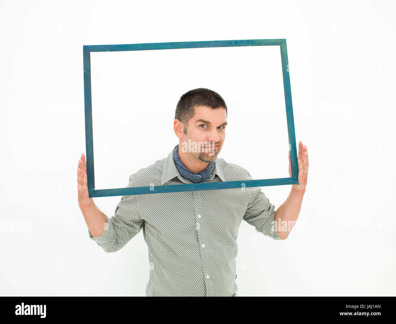 man holding an empty frame with grumpy facial expression, on white ...