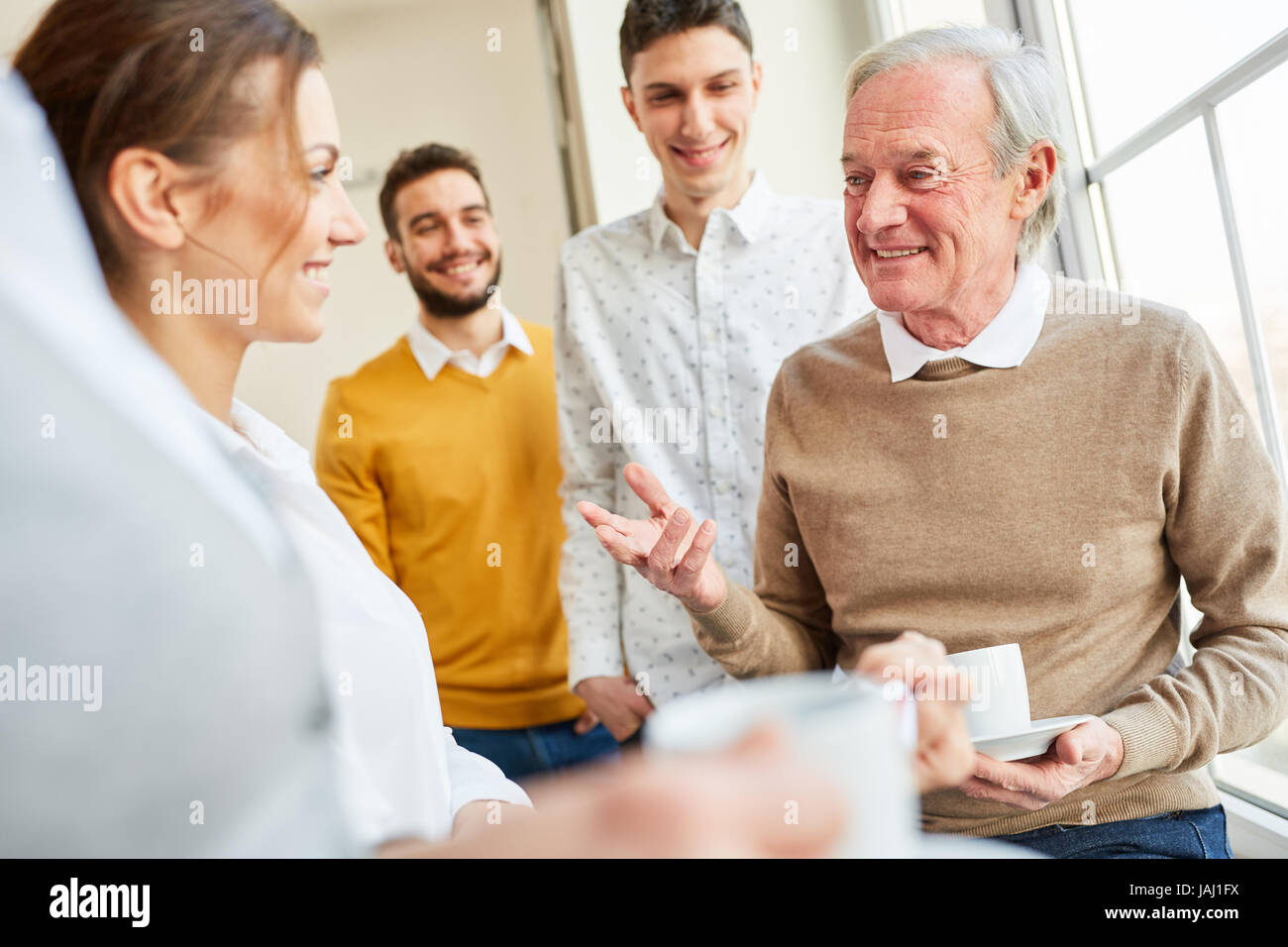 Students and senior making small talk in seminar coffee break Stock ...
