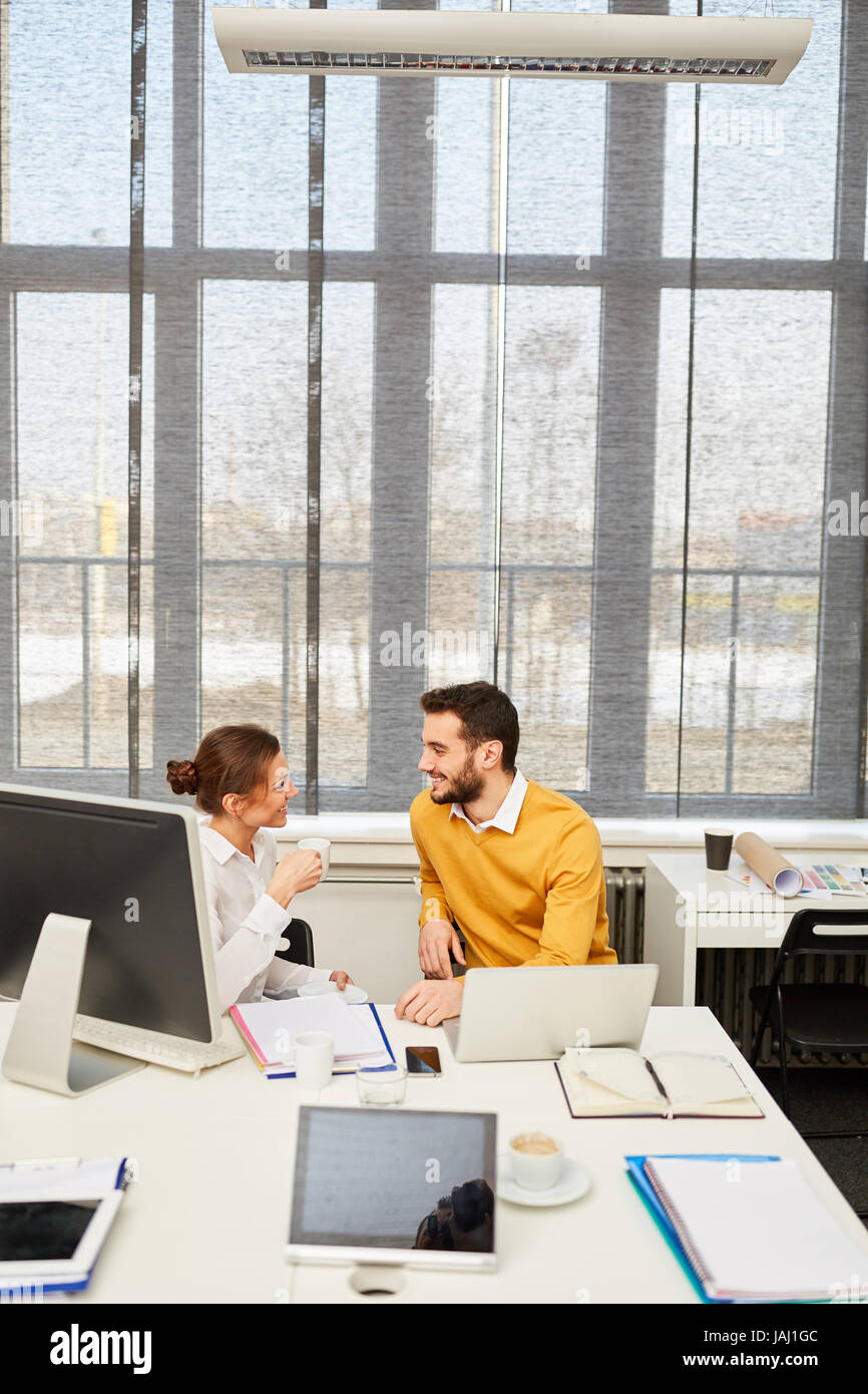 Trainee and man working together as a team in start-up Stock Photo - Alamy