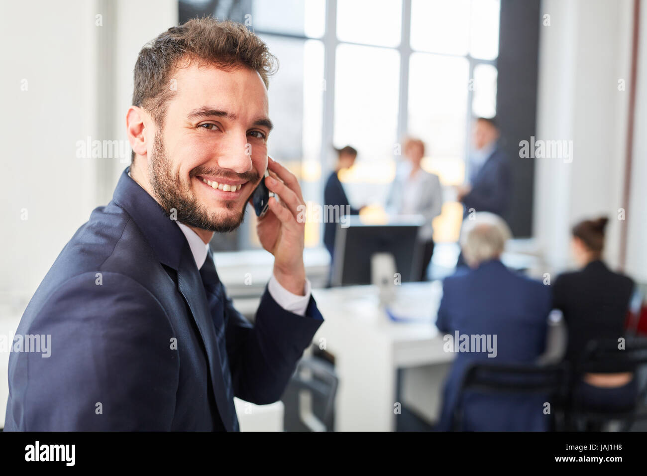 Start-up man calling with smartphone and receiving message with joy ...