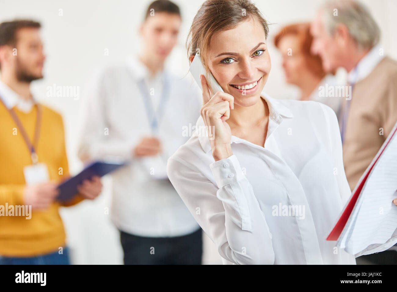 Start-up woman with smartphone making a successful call Stock Photo - Alamy