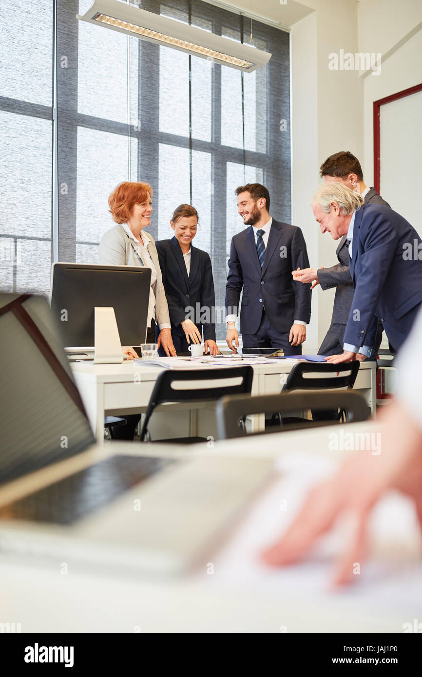 Business people in meeting with laptop computer on desk Stock Photo - Alamy