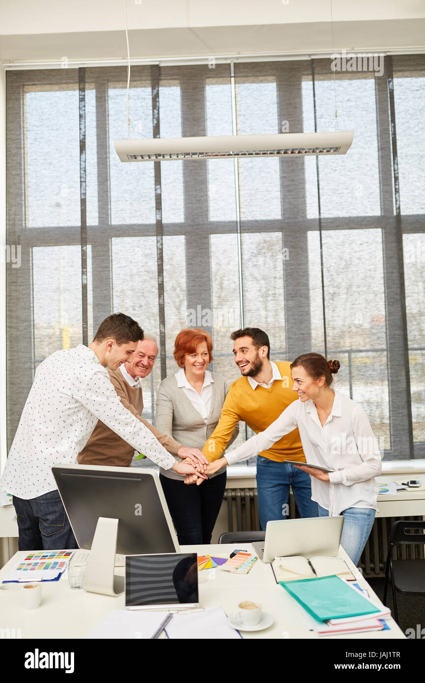 Colleagues making business team building exercise as success and ...