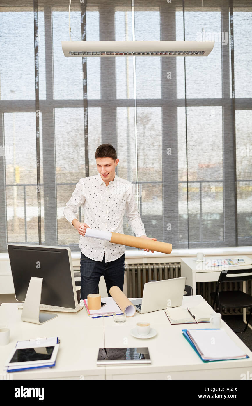 Young architect with achitectural drawing in apprenticeship Stock Photo ...