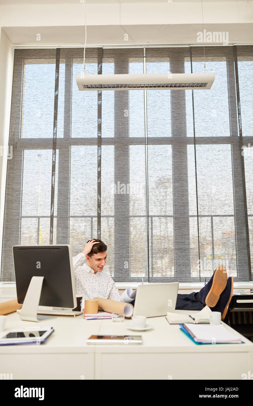Architect thinks about problem in his office Stock Photo - Alamy