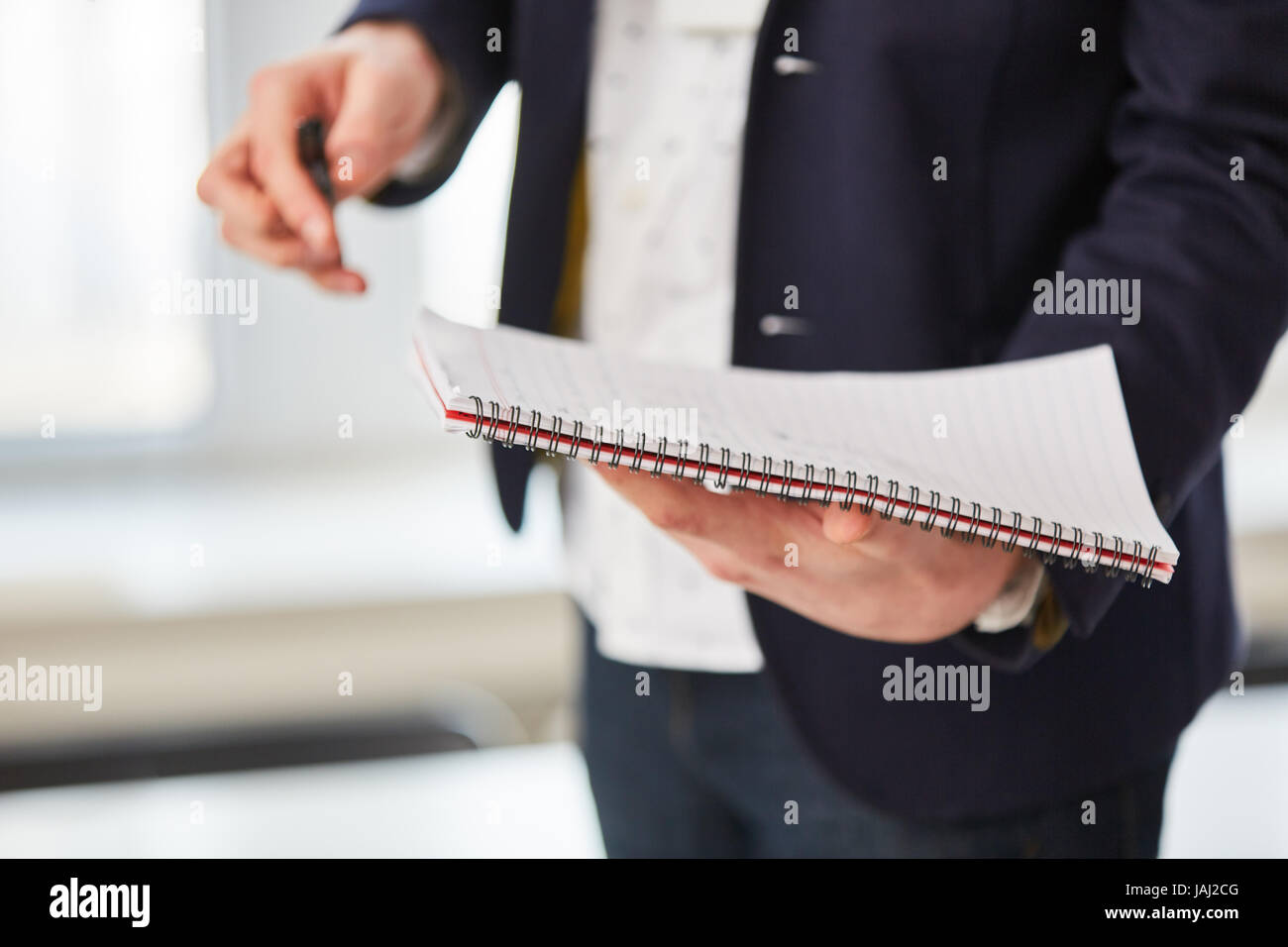 Man holds notebook with ideas and notes for brainstorming workshop ...