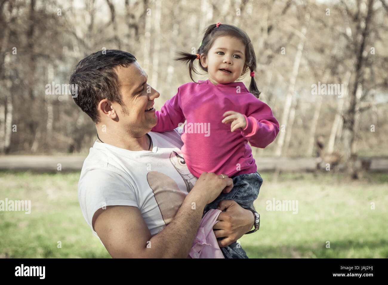 Family portrait of cheerful child and happy smiling dad looking on his ...