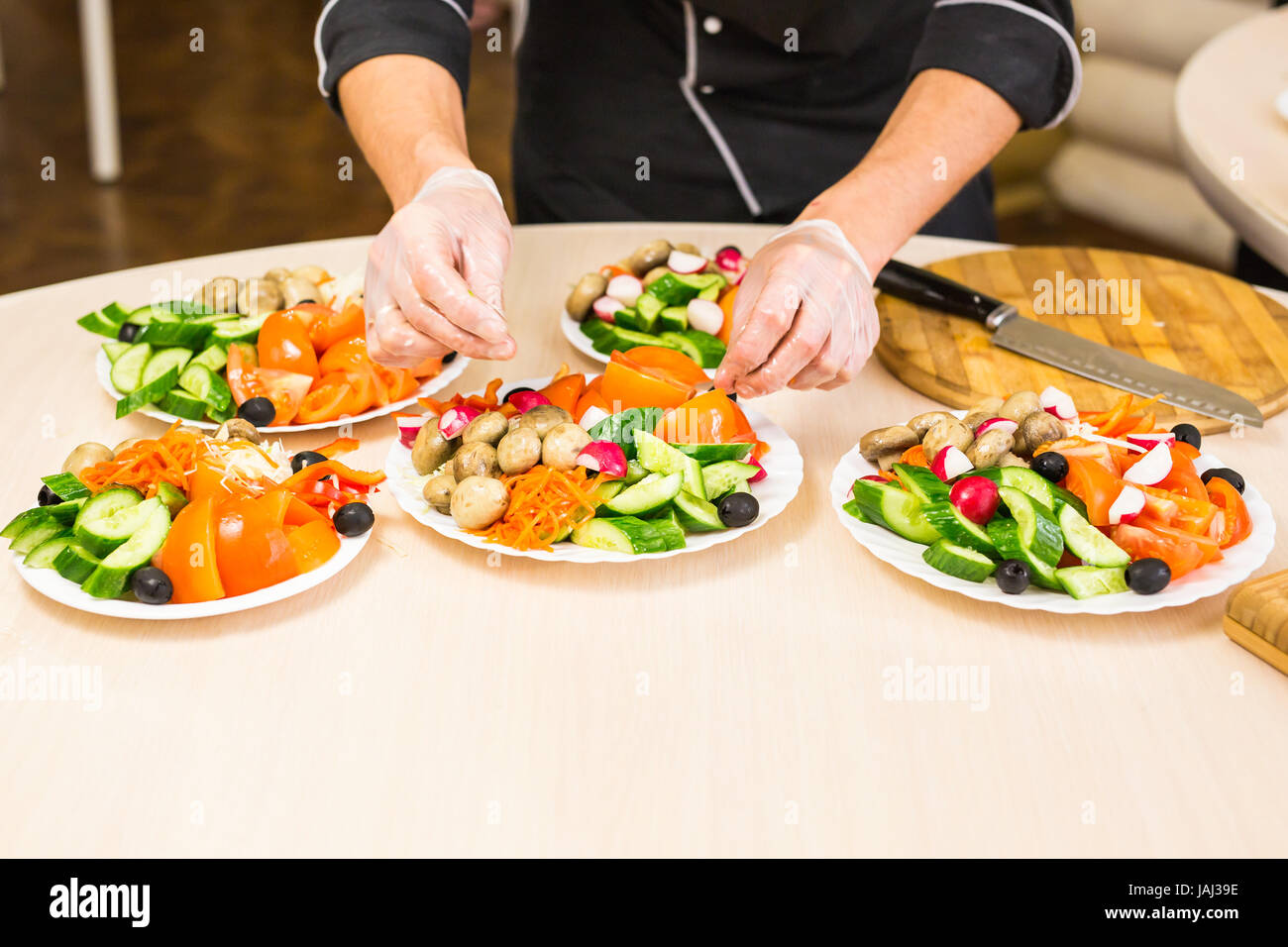 Close-up of chef cooking food kitchen restaurant cutting cook hands ...