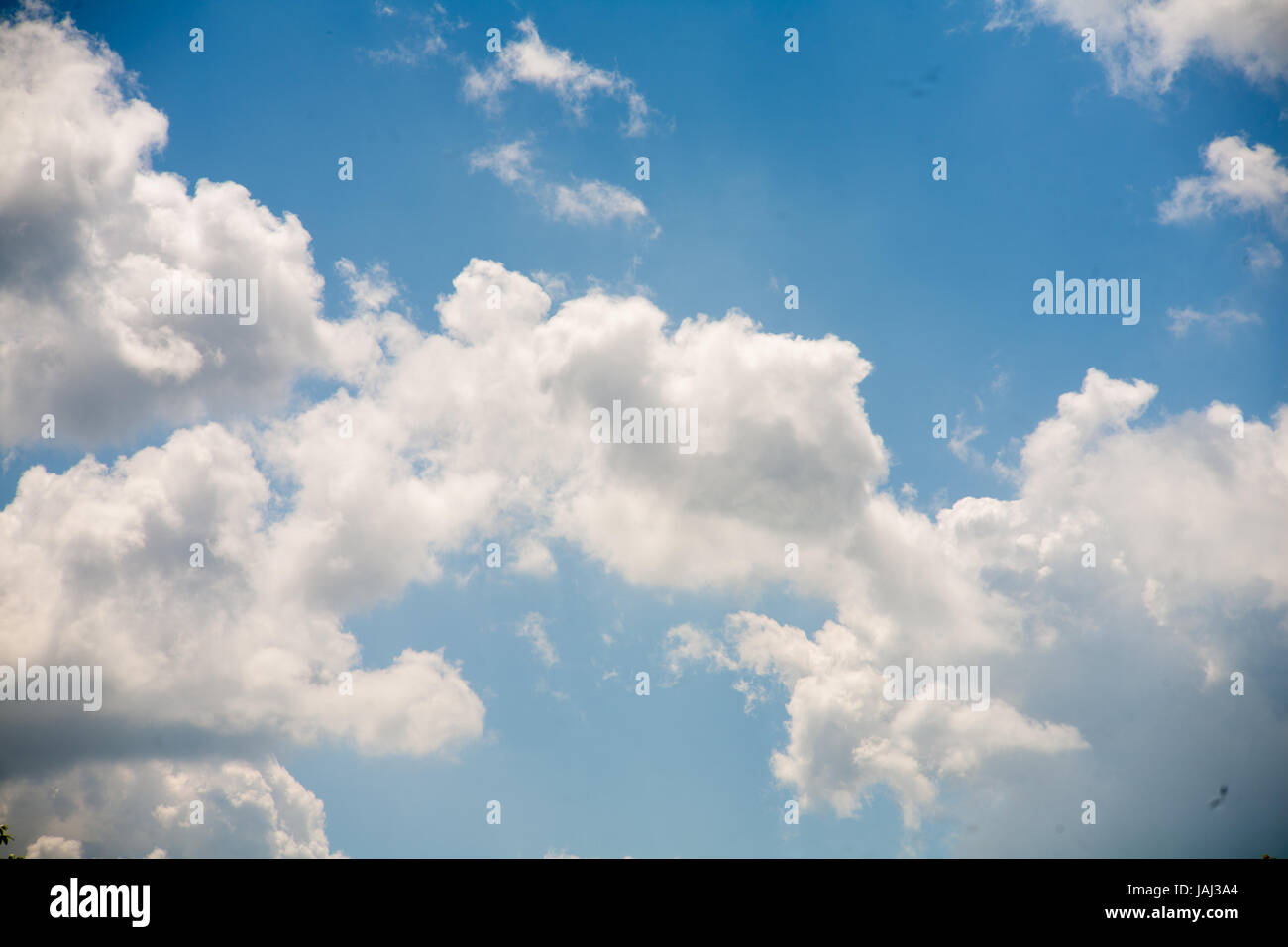 Beautiful white clouds on a background of bright blue clear sky ...