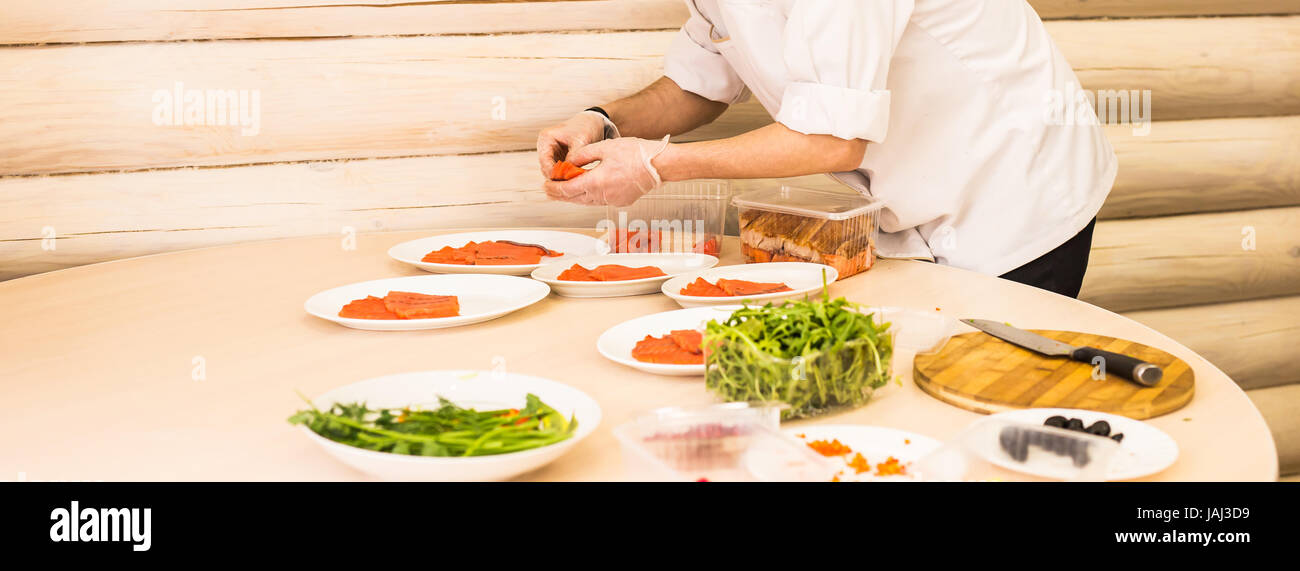 Close-up of chef cooking food kitchen restaurant cutting cook hands ...