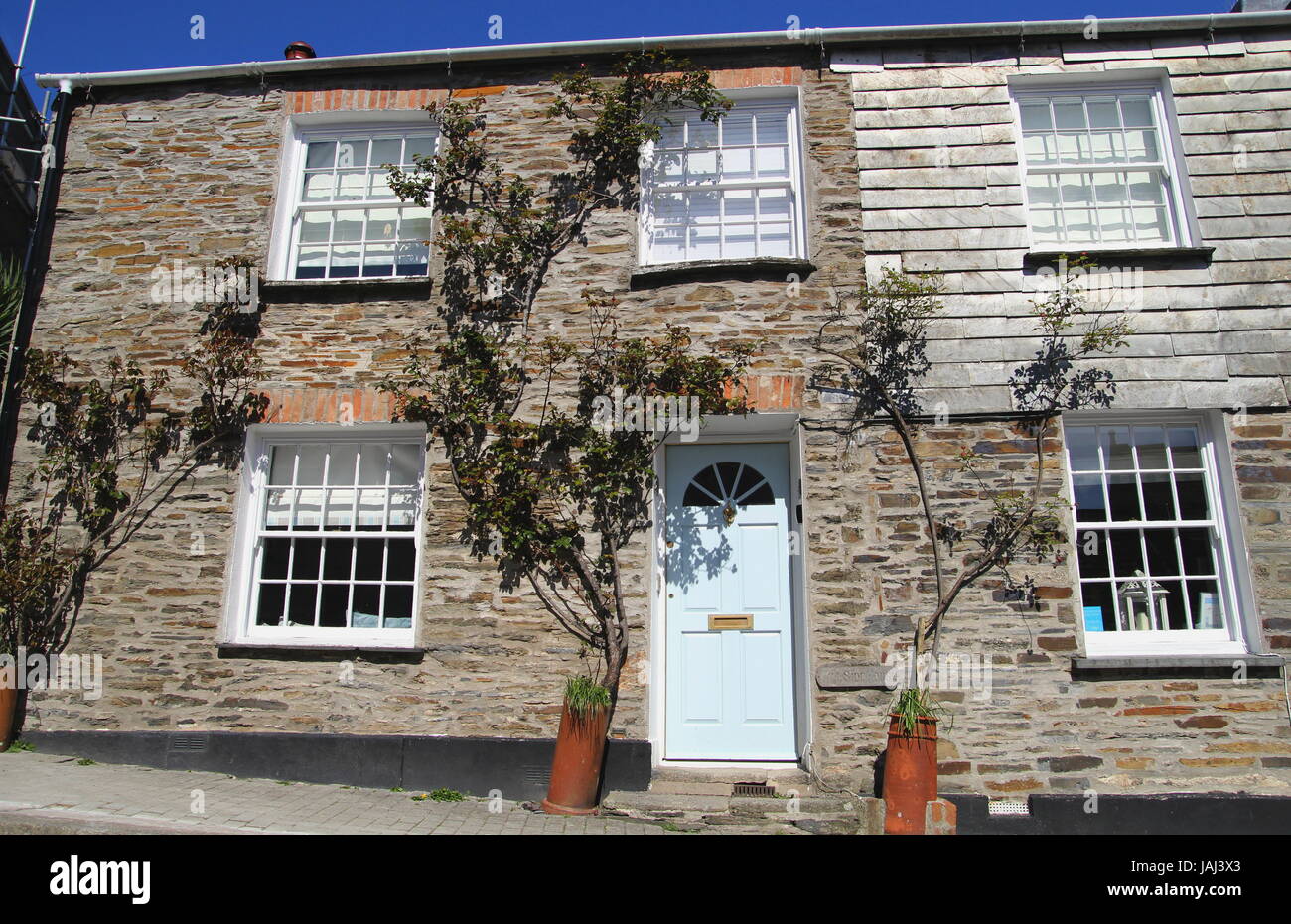 Padstow, Cornwall, UK - April 6th 2017: Pretty stone cottage in a ...