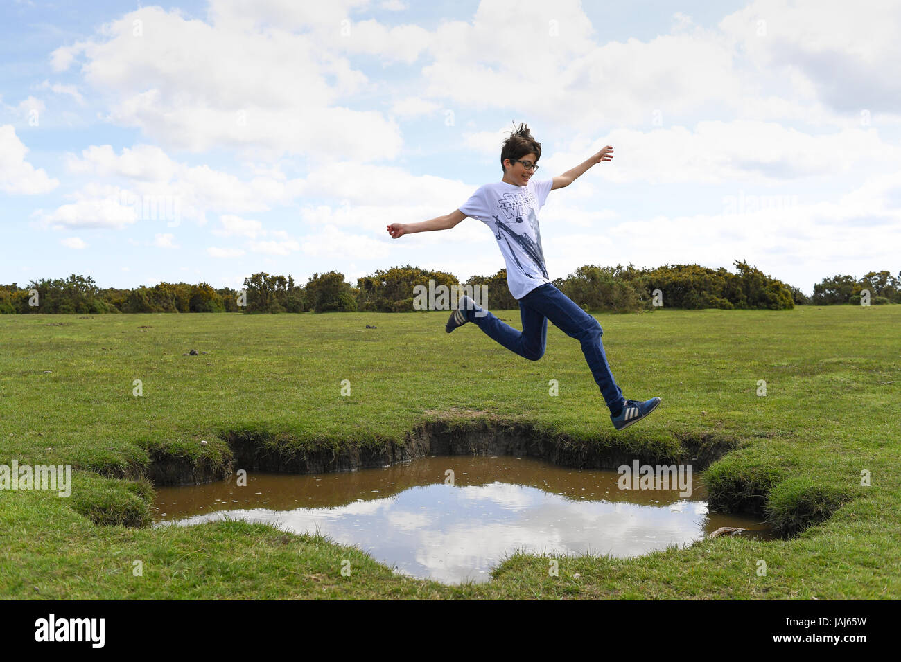 Boy jumping in puddle hi-res stock photography and images - Alamy